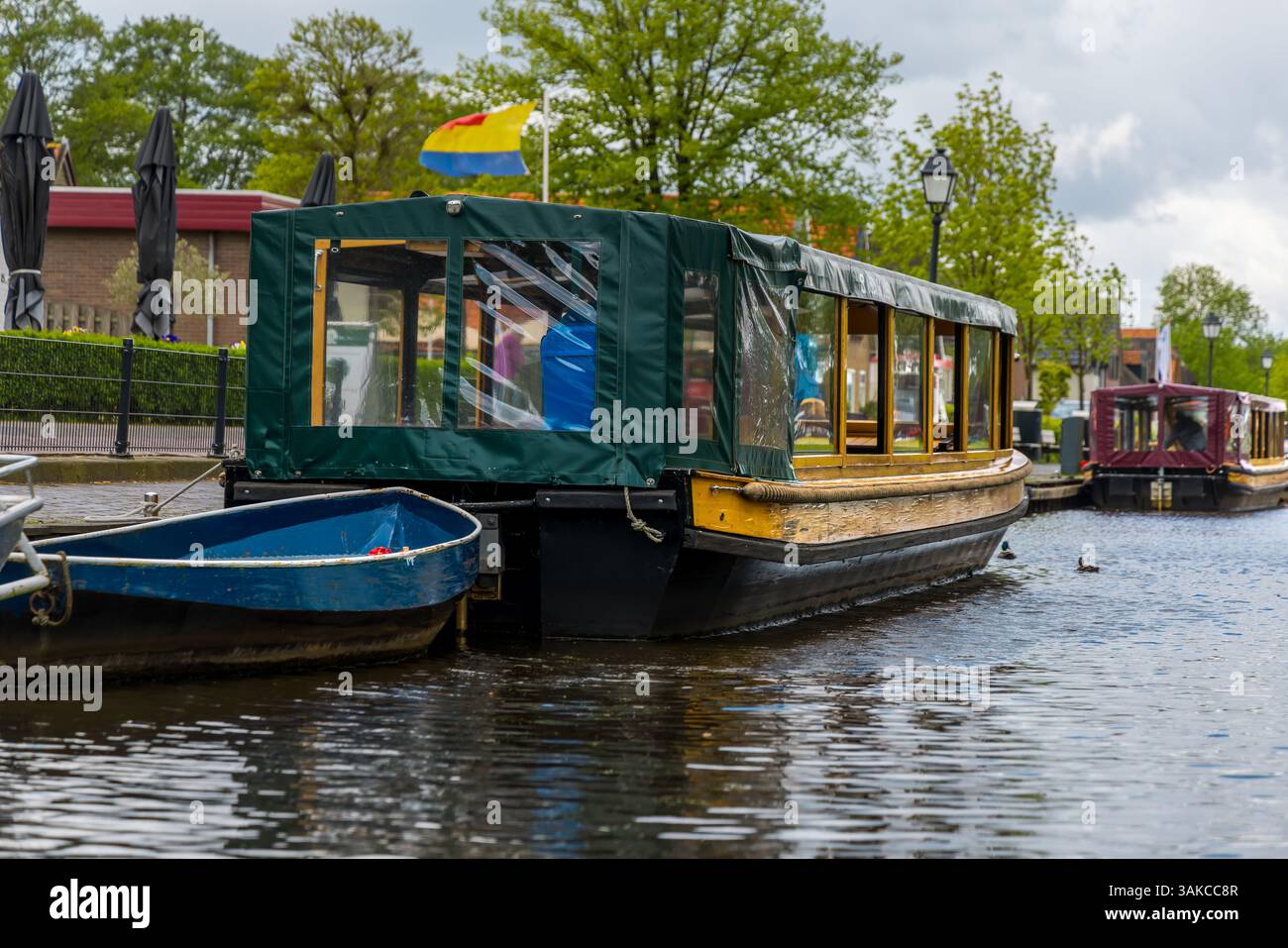 Traditional yellow tour boat in famous Giethoorn village in the ...