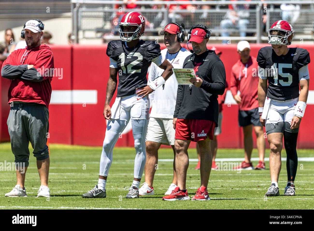 Alabama offensive coordinator Ryan Grubb, red shorts, stands with Alabama quarterback Keelon ...