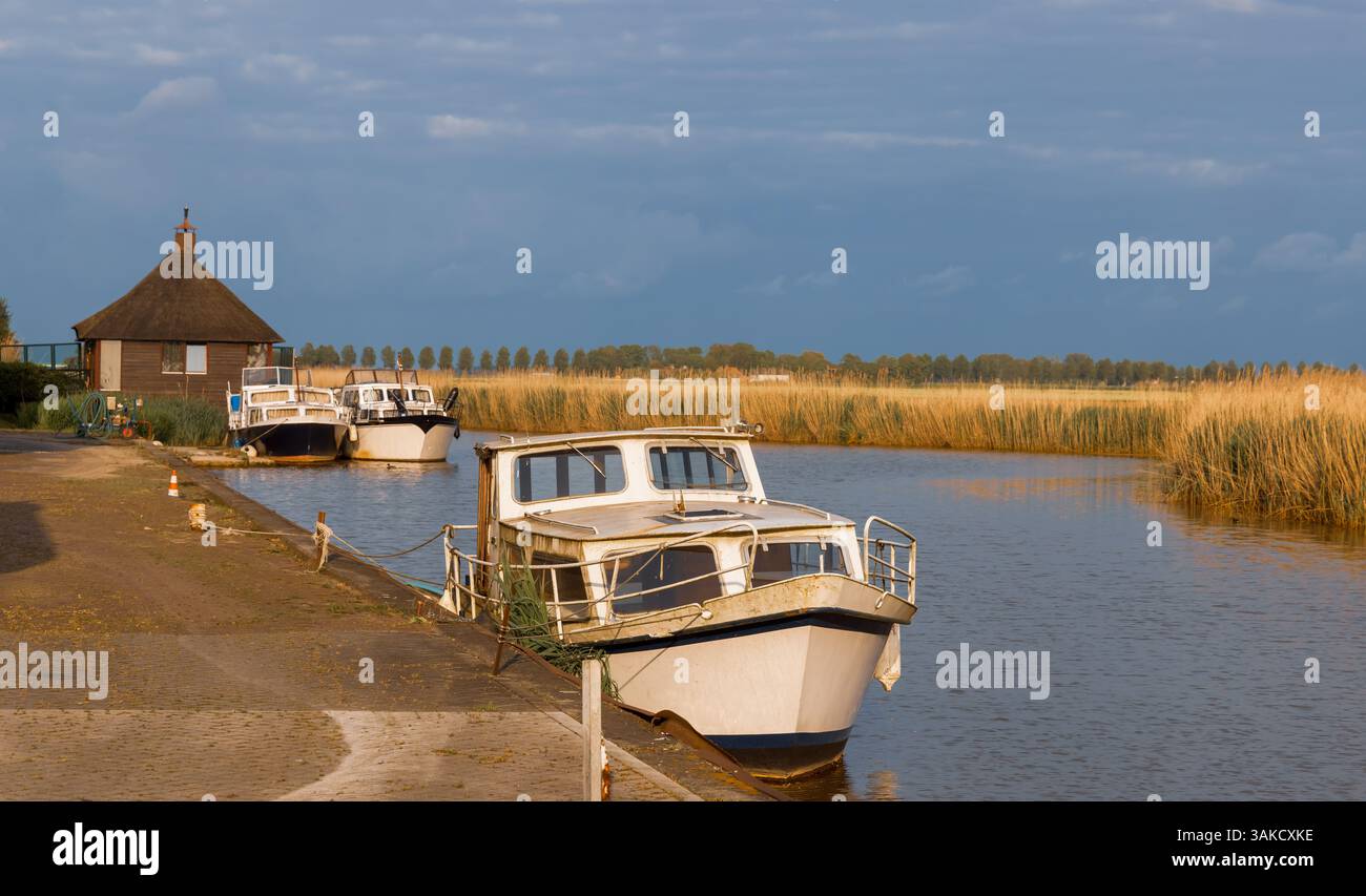 A white boat at the dock in the Netherlands countryside Stock Photo - Alamy