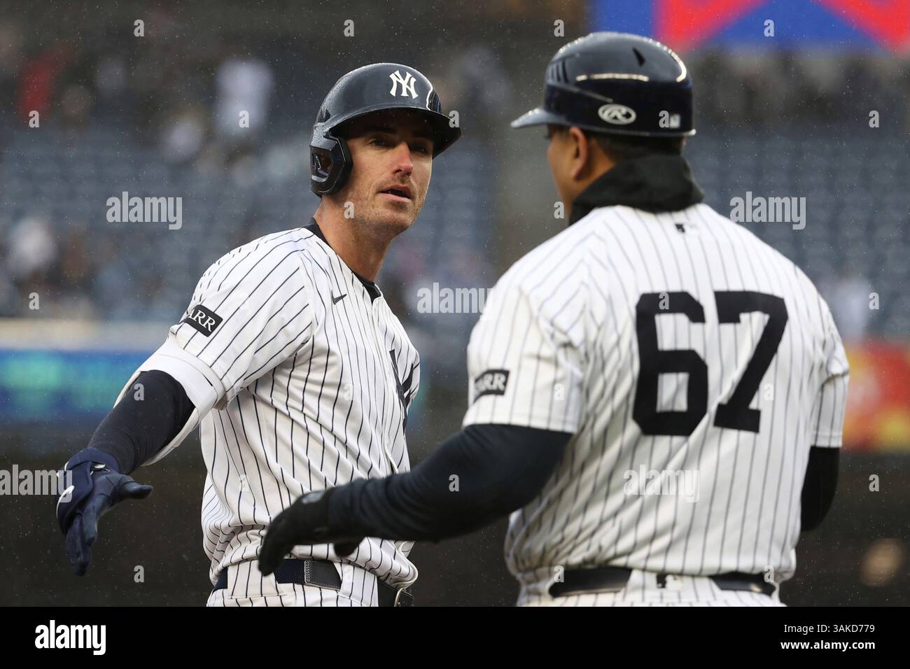 New York Yankees' Cody Bellinger, left, celebrates with third base ...