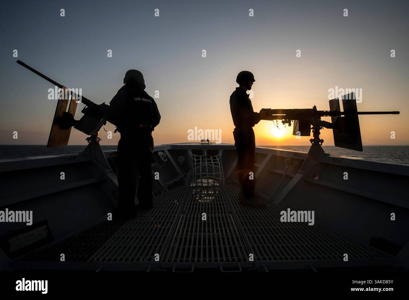 July 7, 2014 - At sea - U.S. Navy sailors are silhouetted by the ...