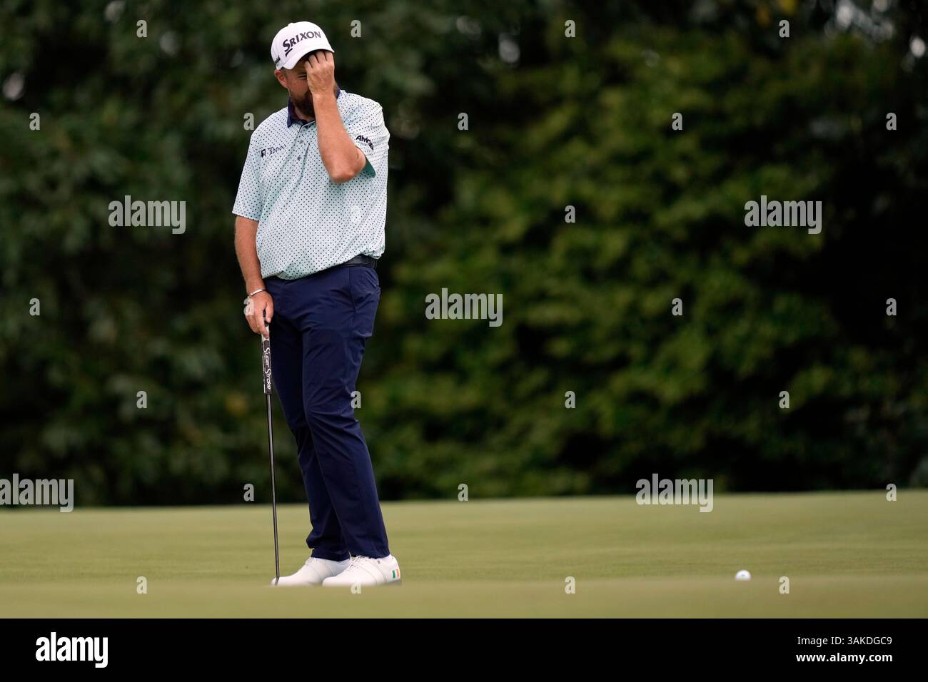 Shane Lowry, of Ireland, reacts after missing a putt on the fifth hole ...