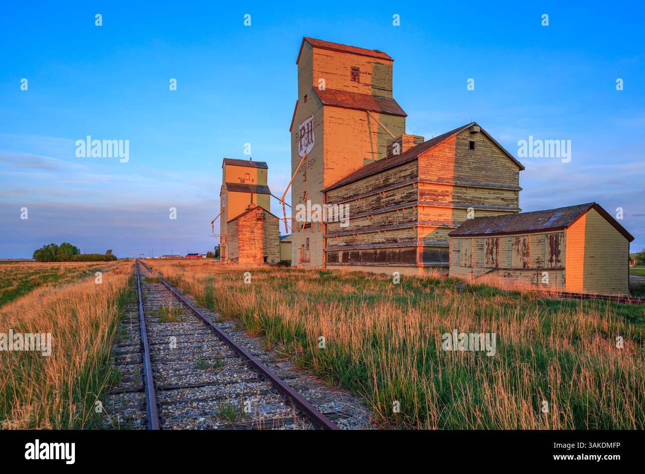 Dilapidated wooden grain elevators along a railroad siding in Mossleigh ...