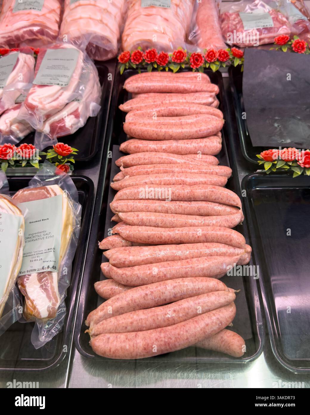 Pork sausage links on display in traditional british butcher shop Stock ...