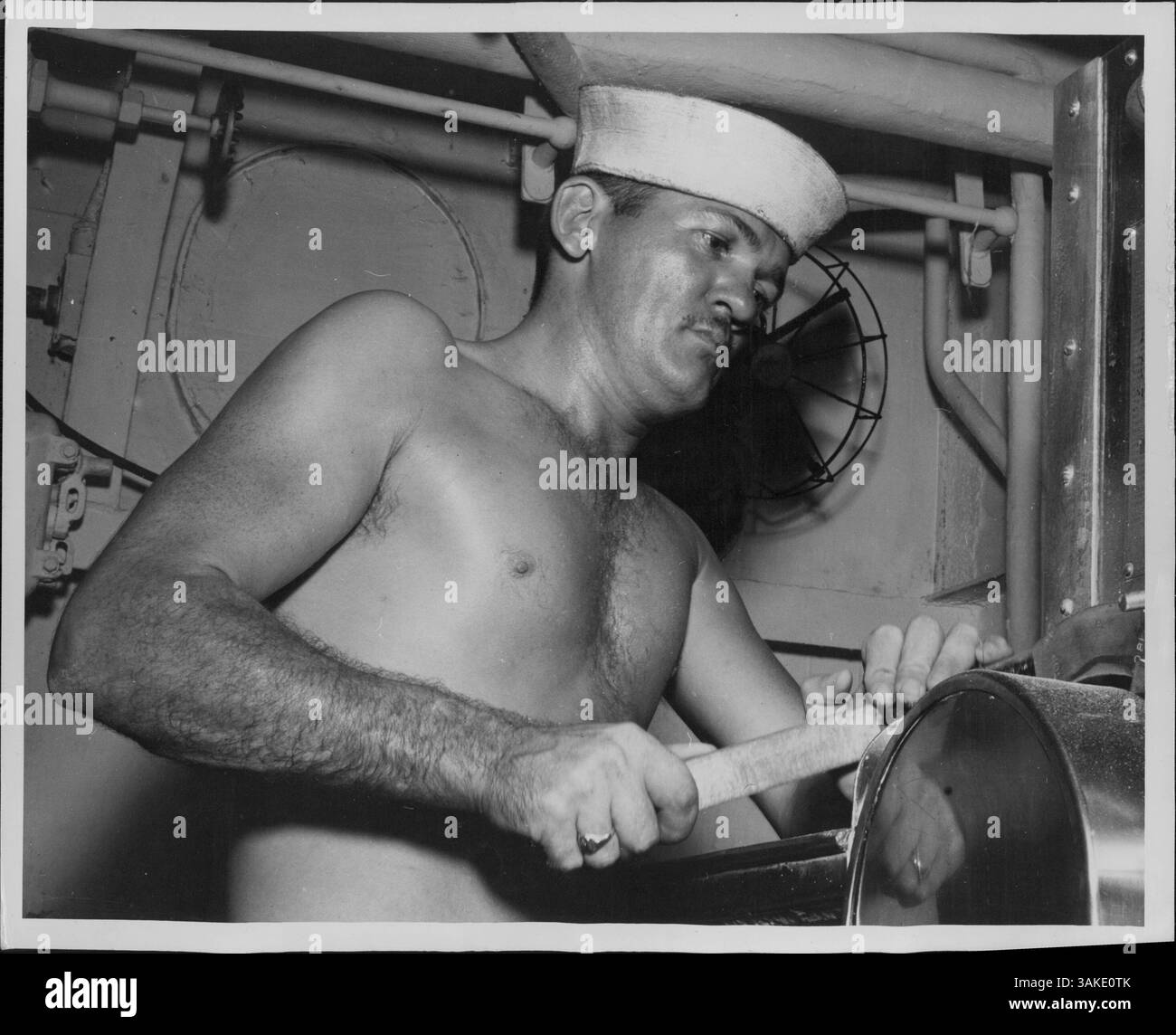 Fireman First Class Newman Nelson, a Coast Guardsman, is pictured checking the machinery in the ...