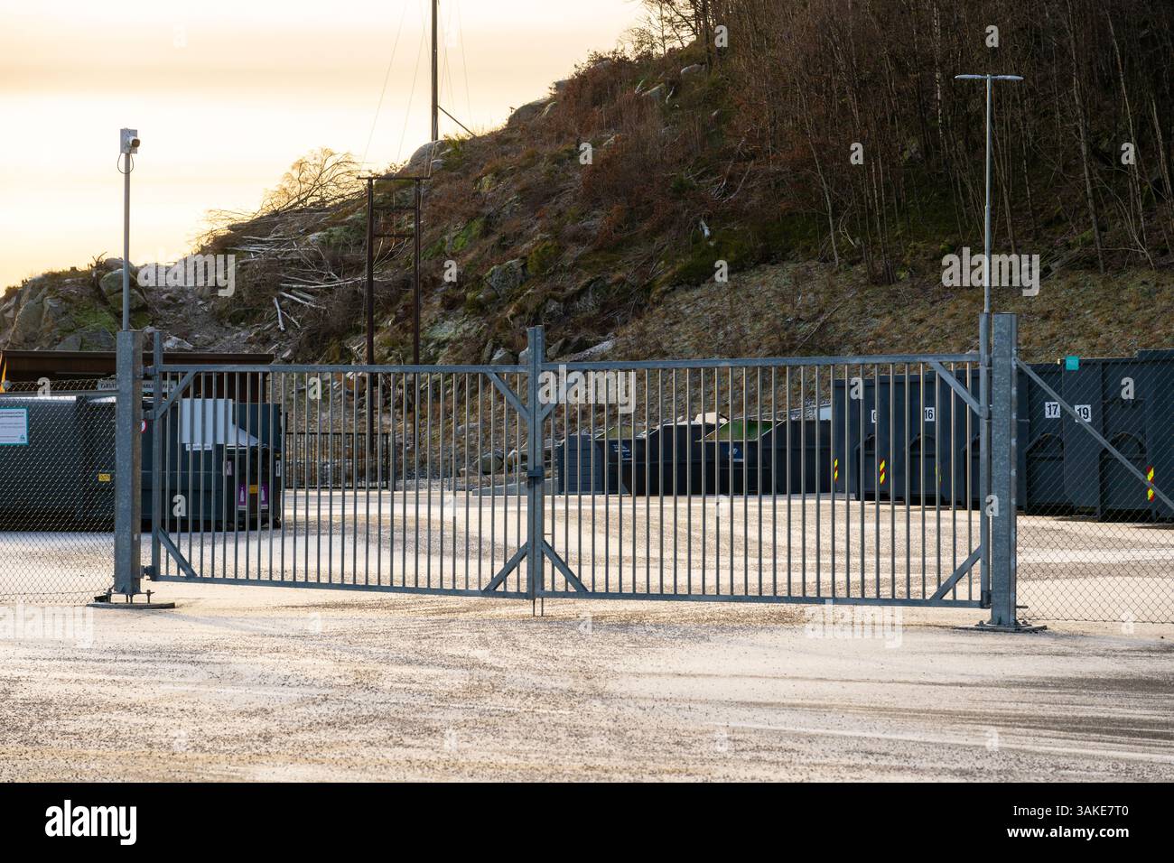 Closed gate of a recycling station Stock Photo - Alamy
