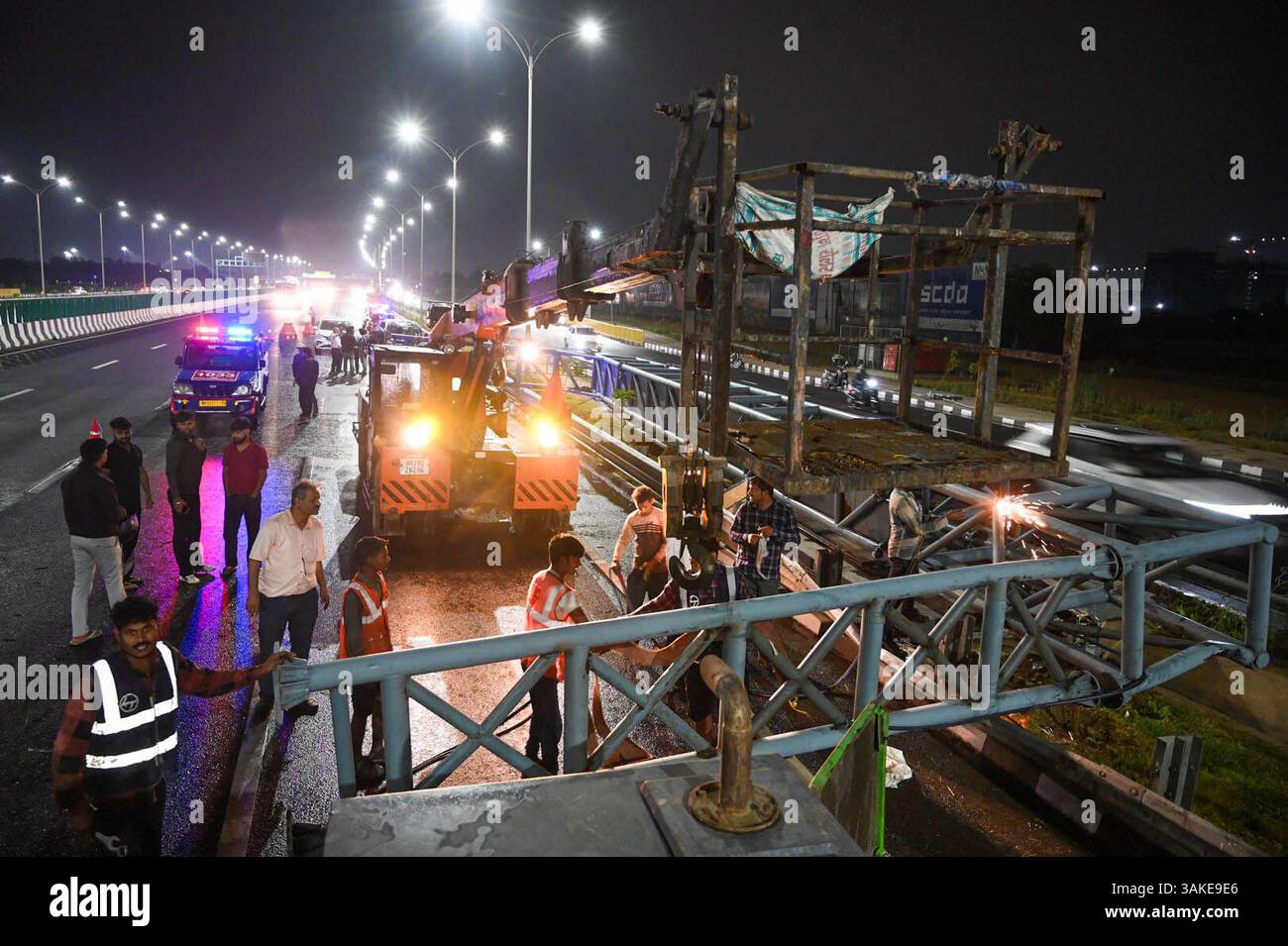 GURUGRAM, INDIA - APRIL 11: Workers seen trying to remove the sign ...