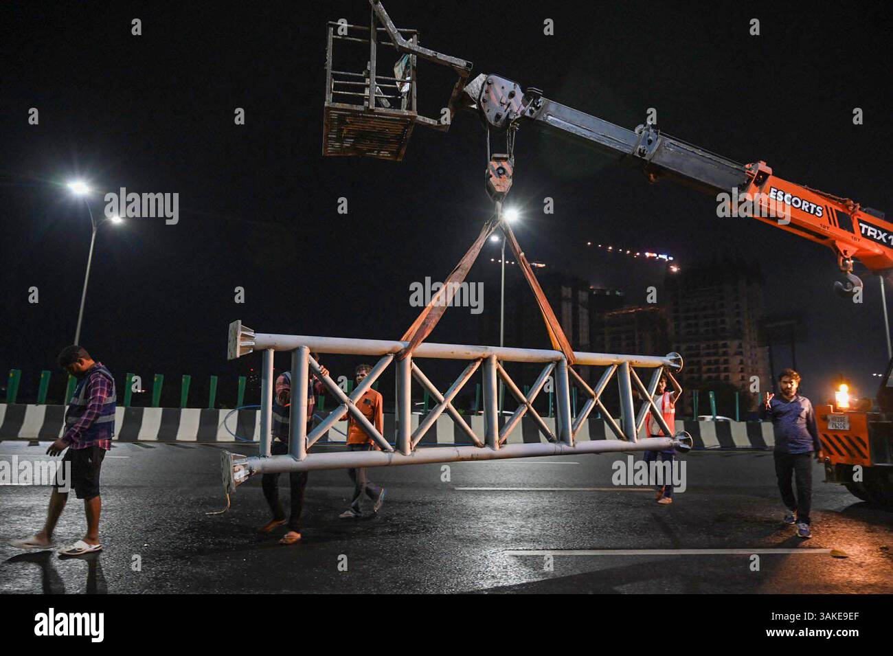 GURUGRAM, INDIA - APRIL 11: Workers seen trying to remove the sign ...