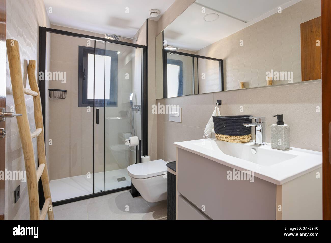 Modern bathroom featuring a glass shower, textured wall tiles, and a ...