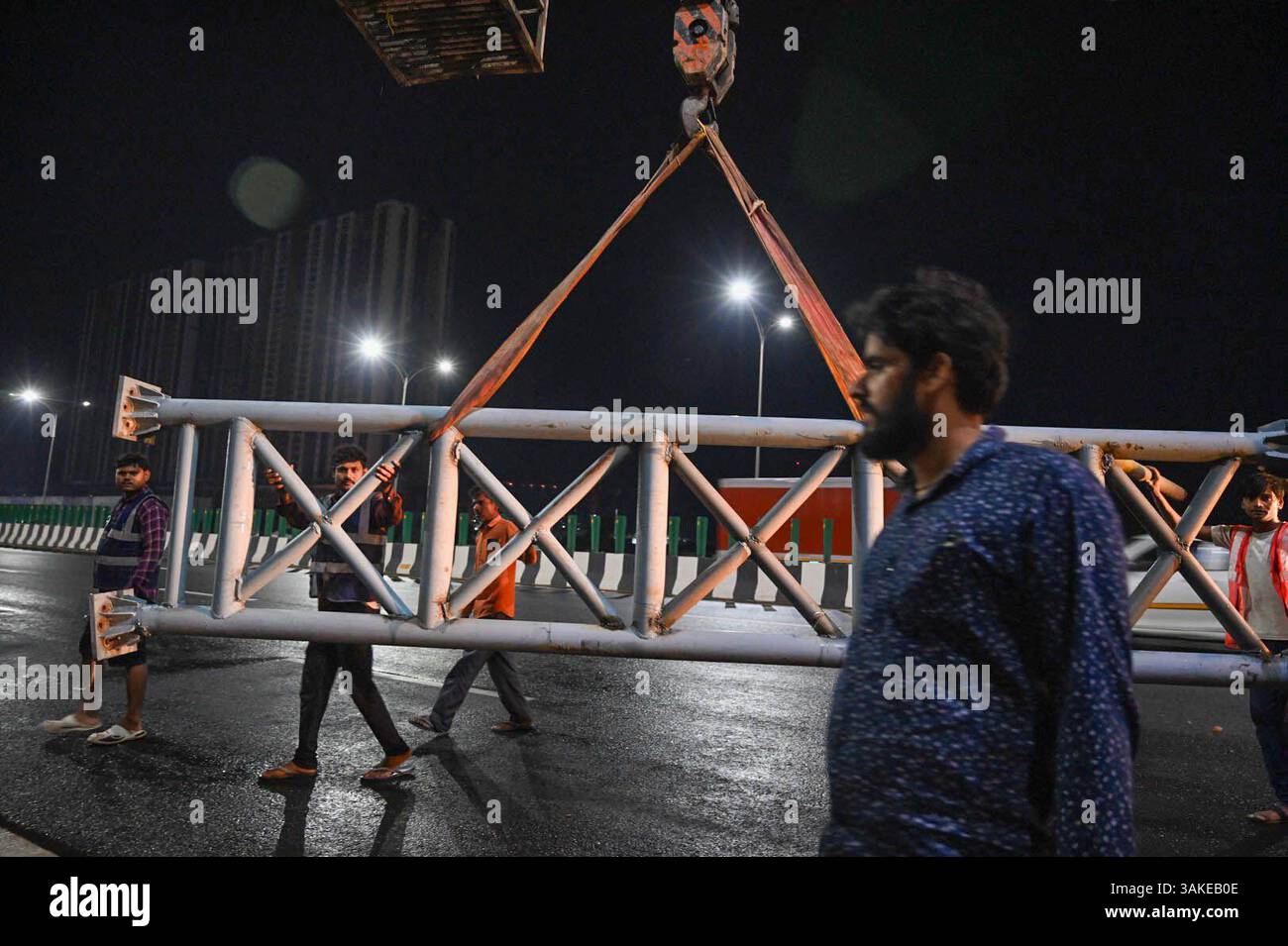 GURUGRAM, INDIA - APRIL 11: Workers seen trying to remove the sign ...
