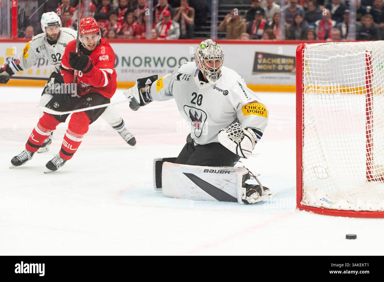 Lausanne Switzerland, 04 12 2025: Reto Berra (goal keeper) of HC Fribourg-Gotteron #20 deflects ...