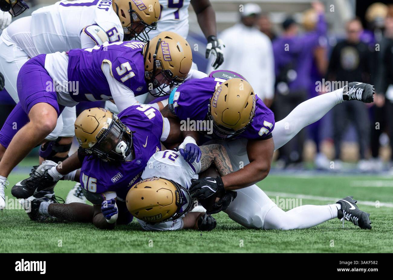 James Madison running back Jackson McCarter (21) is tackled by ...