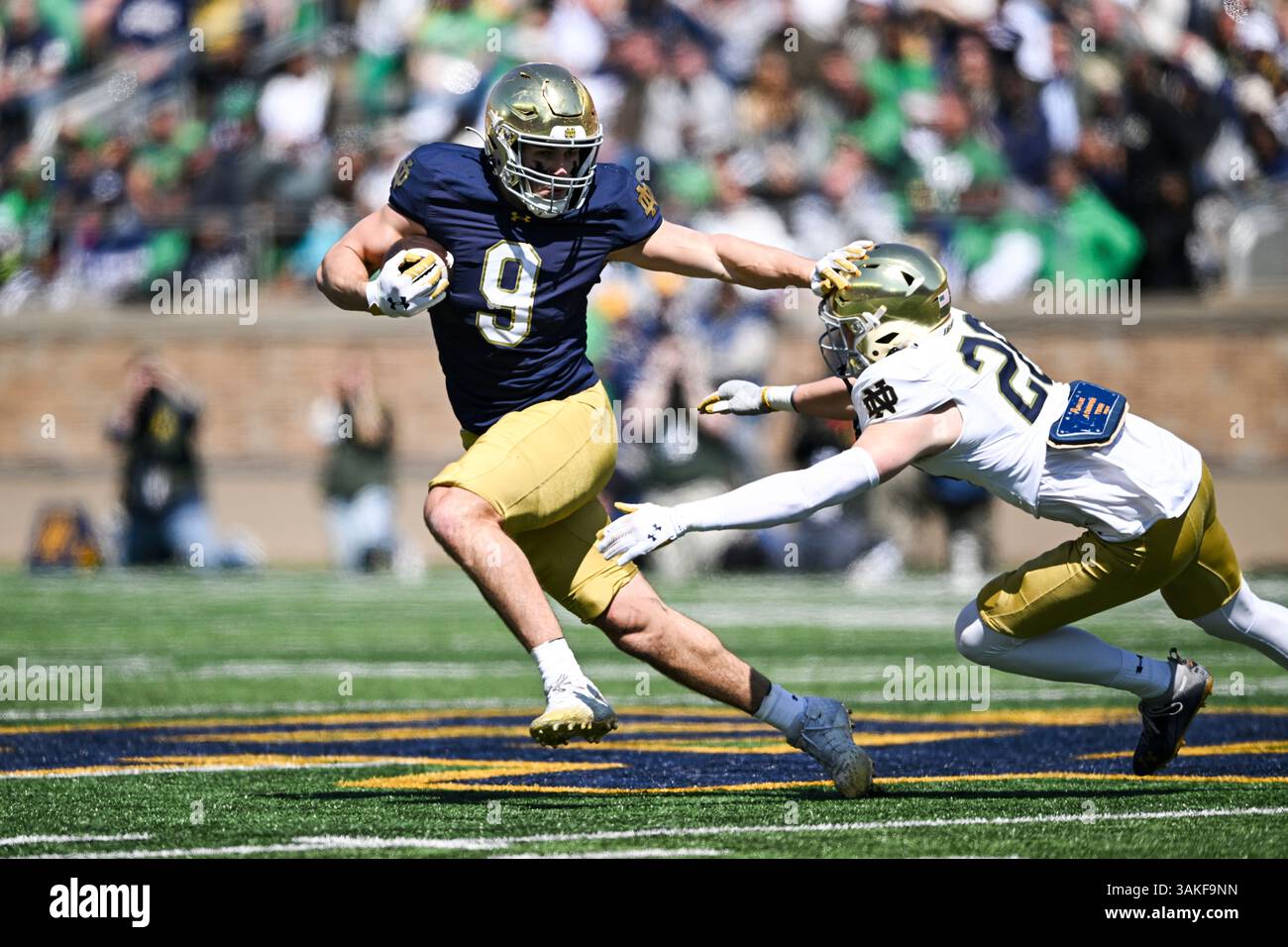 SOUTH BEND, IN - APRIL 12: Notre Dame TE Eli Raridon (9) stiff arms ...