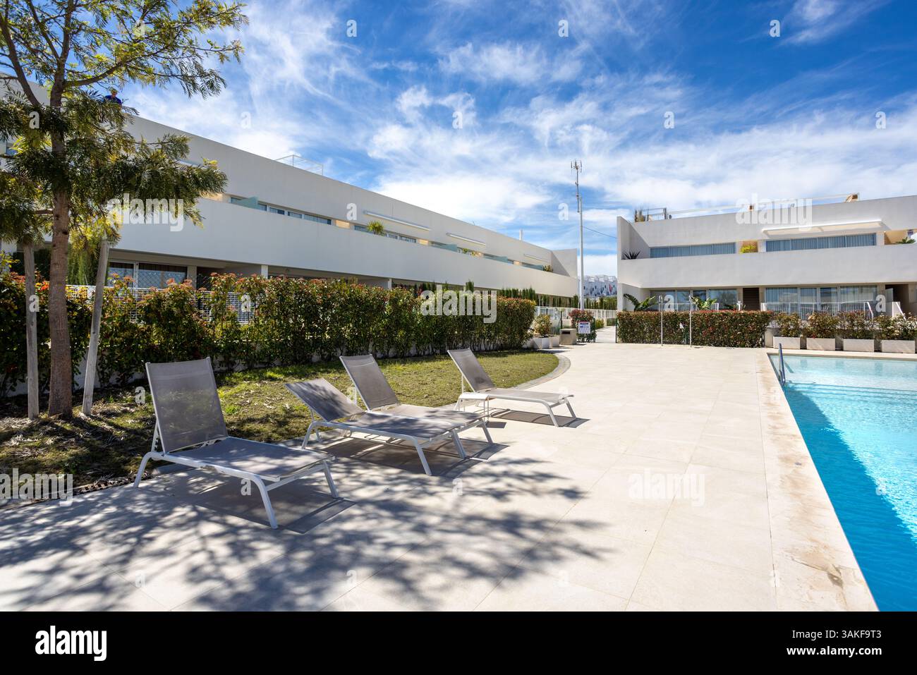 Stainless steel rain showers with running water beside an infinity pool ...