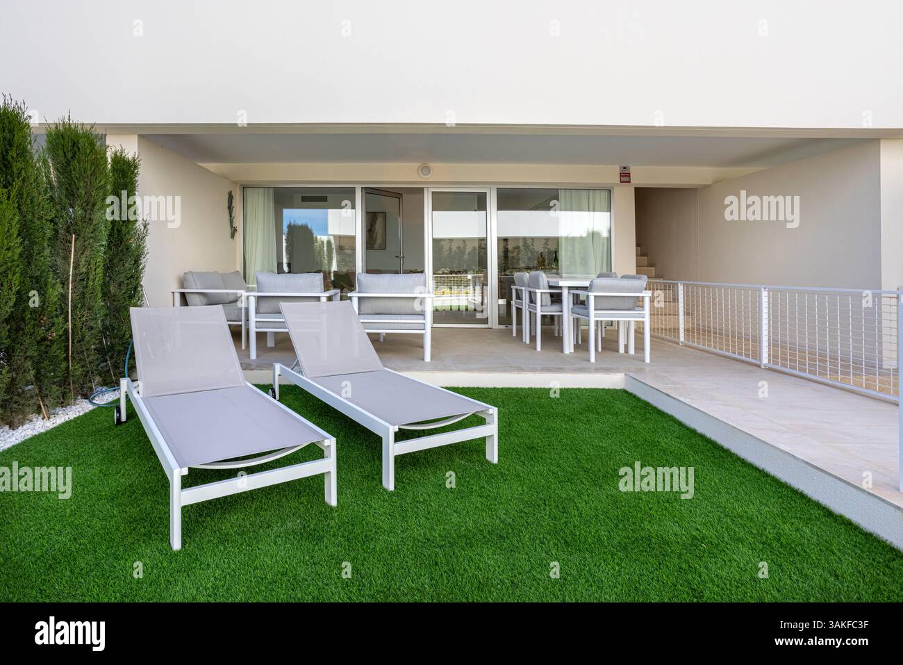 Private outdoor terrace with loungers and seating area, seamlessly ...