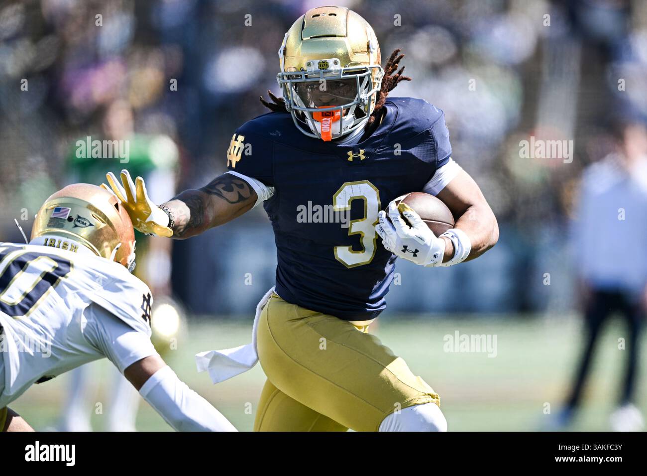 SOUTH BEND, IN - APRIL 12: Notre Dame RB Gi'Bran Payne (3) stiff arms a ...