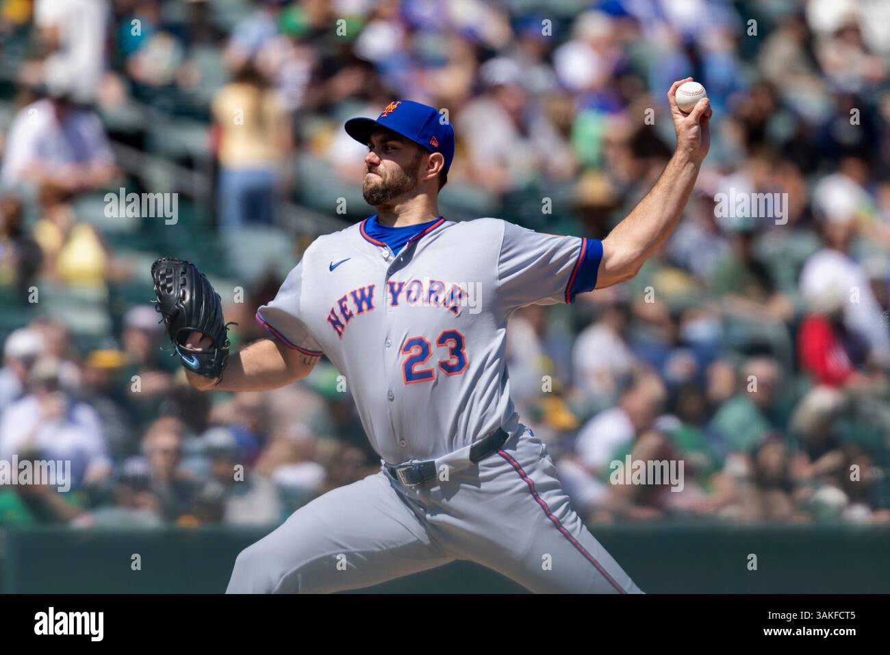 New York Mets pitcher David Peterson (23) throws to the Athletics ...