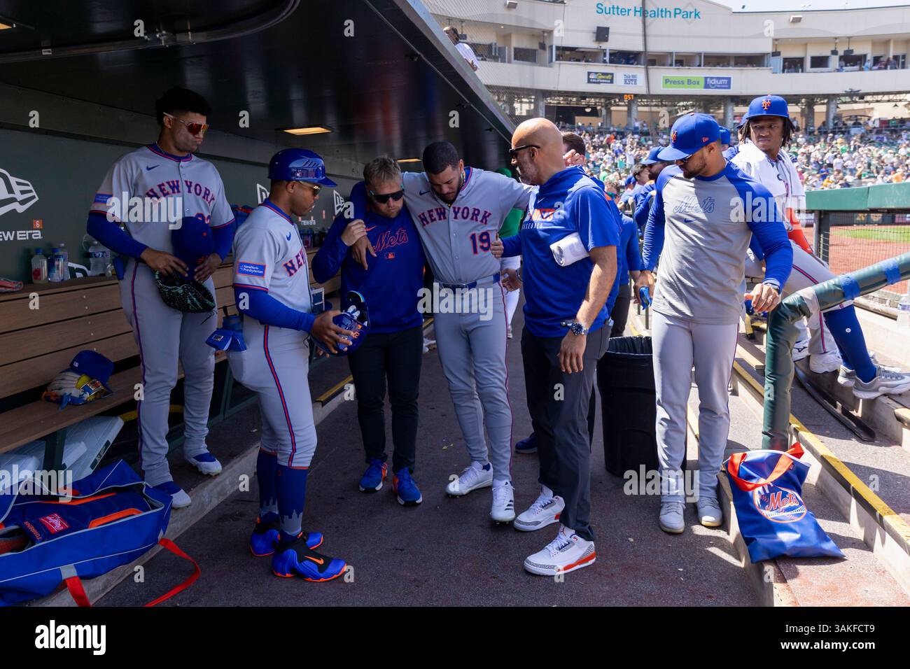 New York Mets outfielder Jose Siri (19) is helped out of the dugout ...
