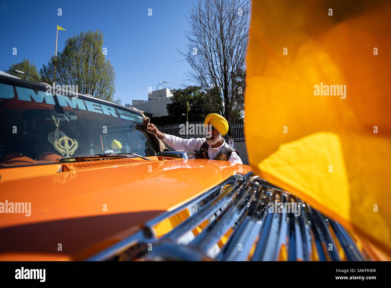 A man cleans a Hummer before the Vaisakhi parade in Vancouver., on ...