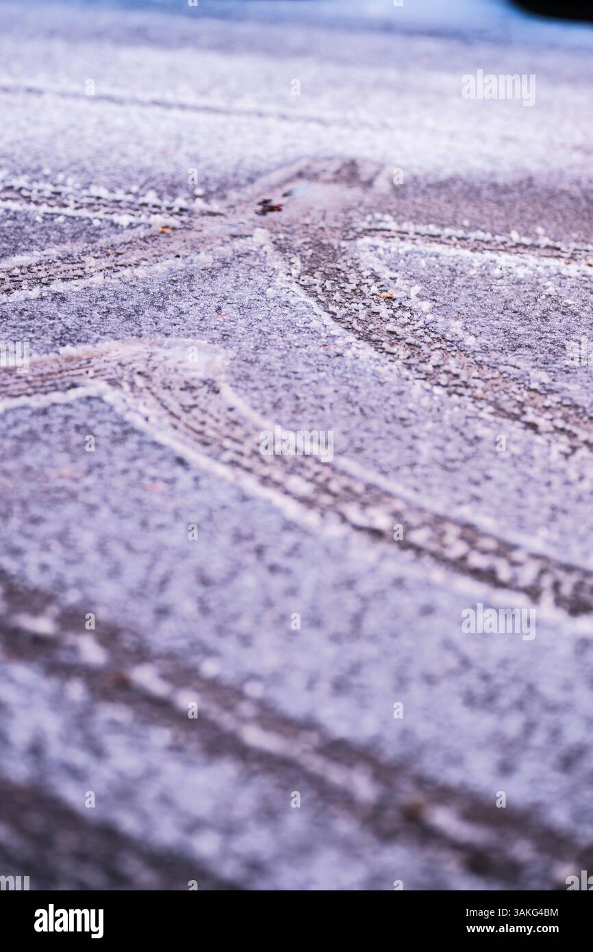 Tire tracks on an icy parking lot Stock Photo - Alamy