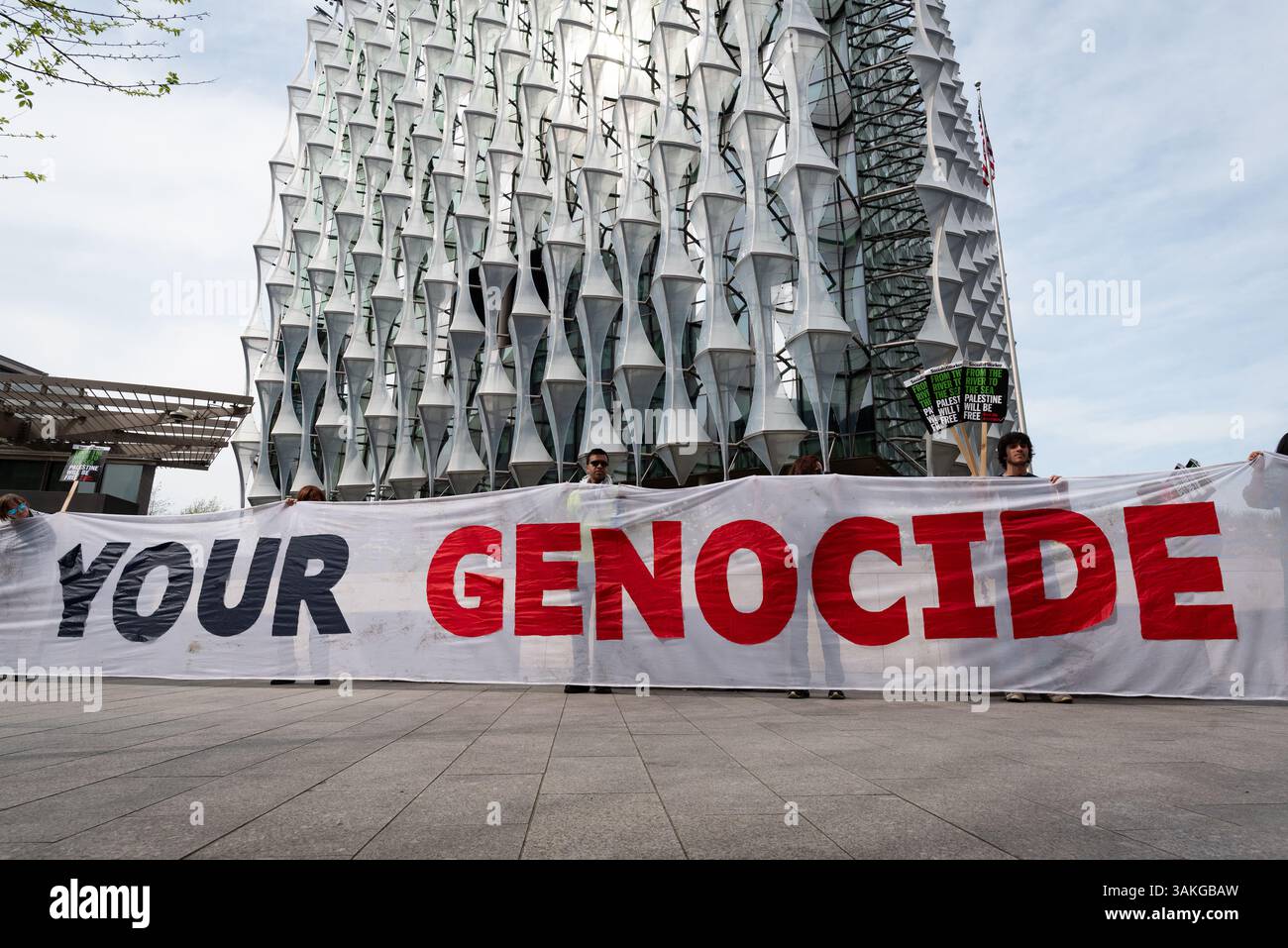 London, UK. 12 April, 2025. A large banner declaring "Your Genocide" is ...