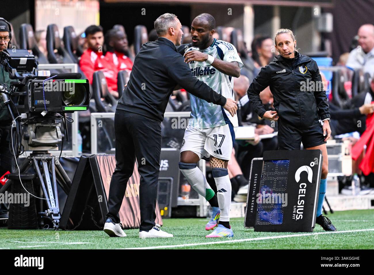 ATLANTA, GA – APRIL 12: New England head coach Caleb Porter embraces ...