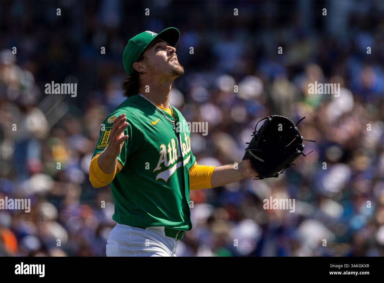 Athletics pitcher J.T. Ginn (70) looks to the sky as he leaves the ...