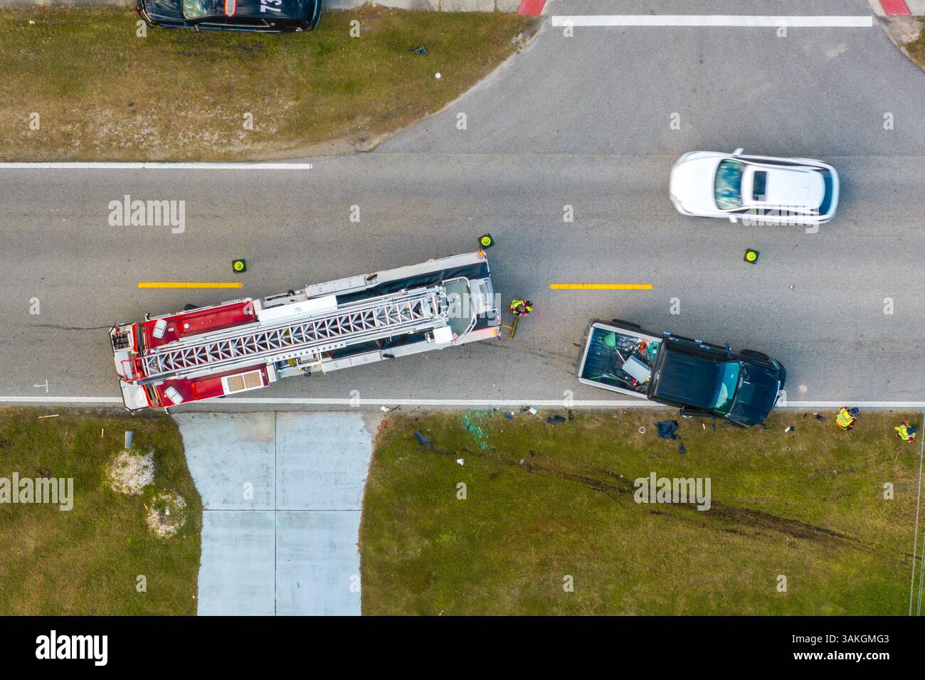 Car crash site with emergency services personnel and vehicles ...