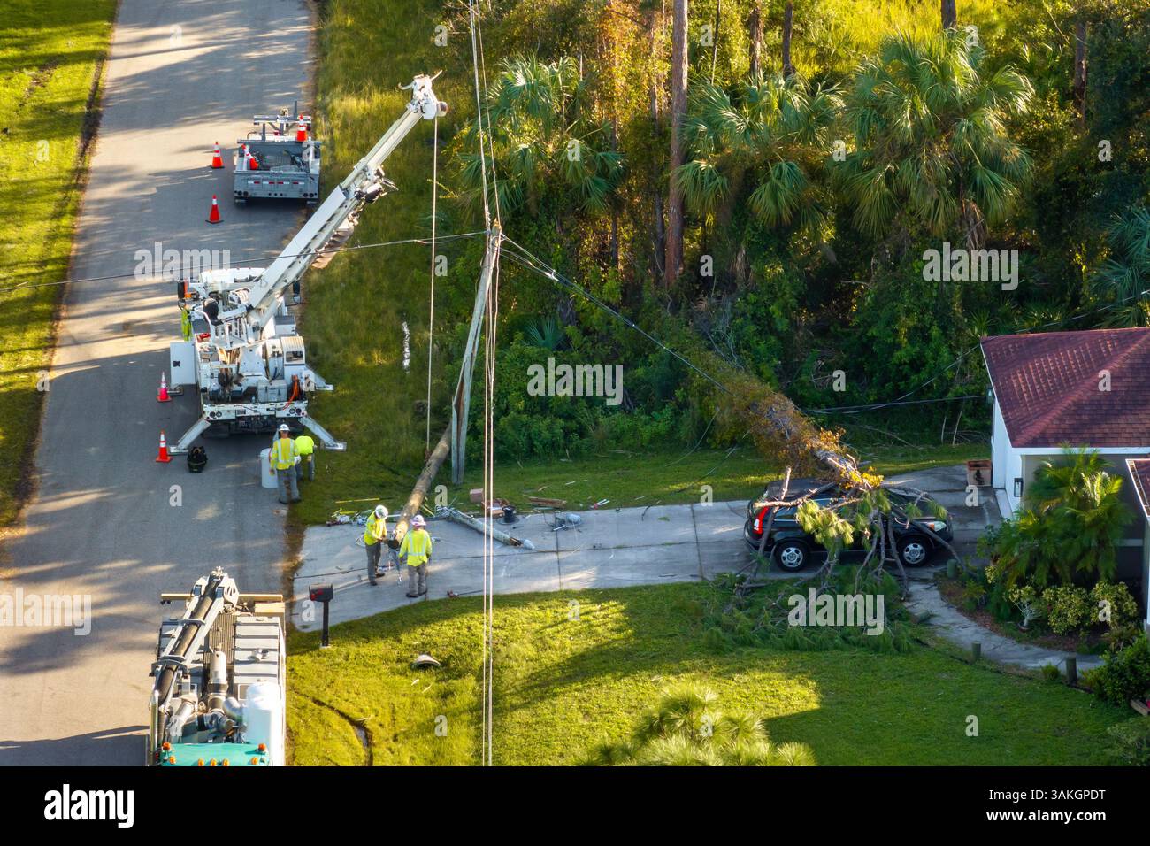 Electrician workers fixing power lines after outage. Repair of damaged ...