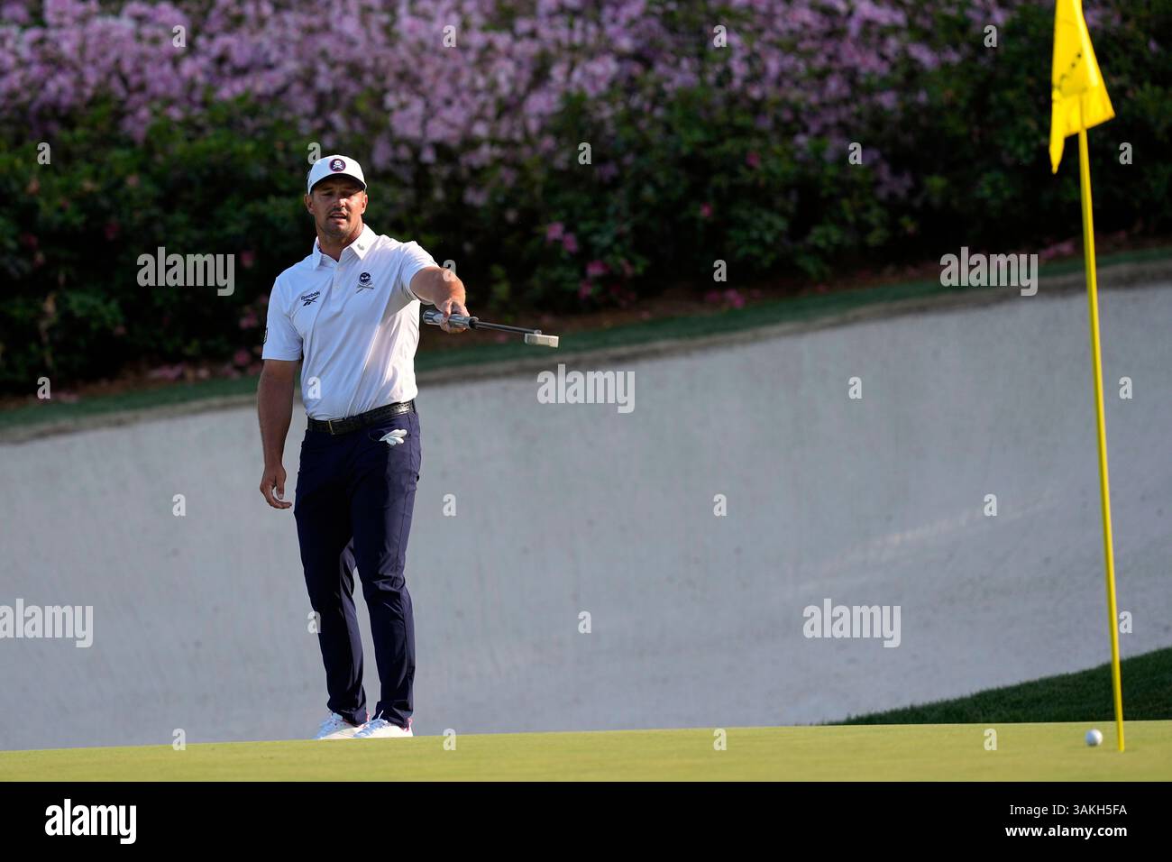 Bryson DeChambeau reacts after missing a putt on the 13th hole during ...
