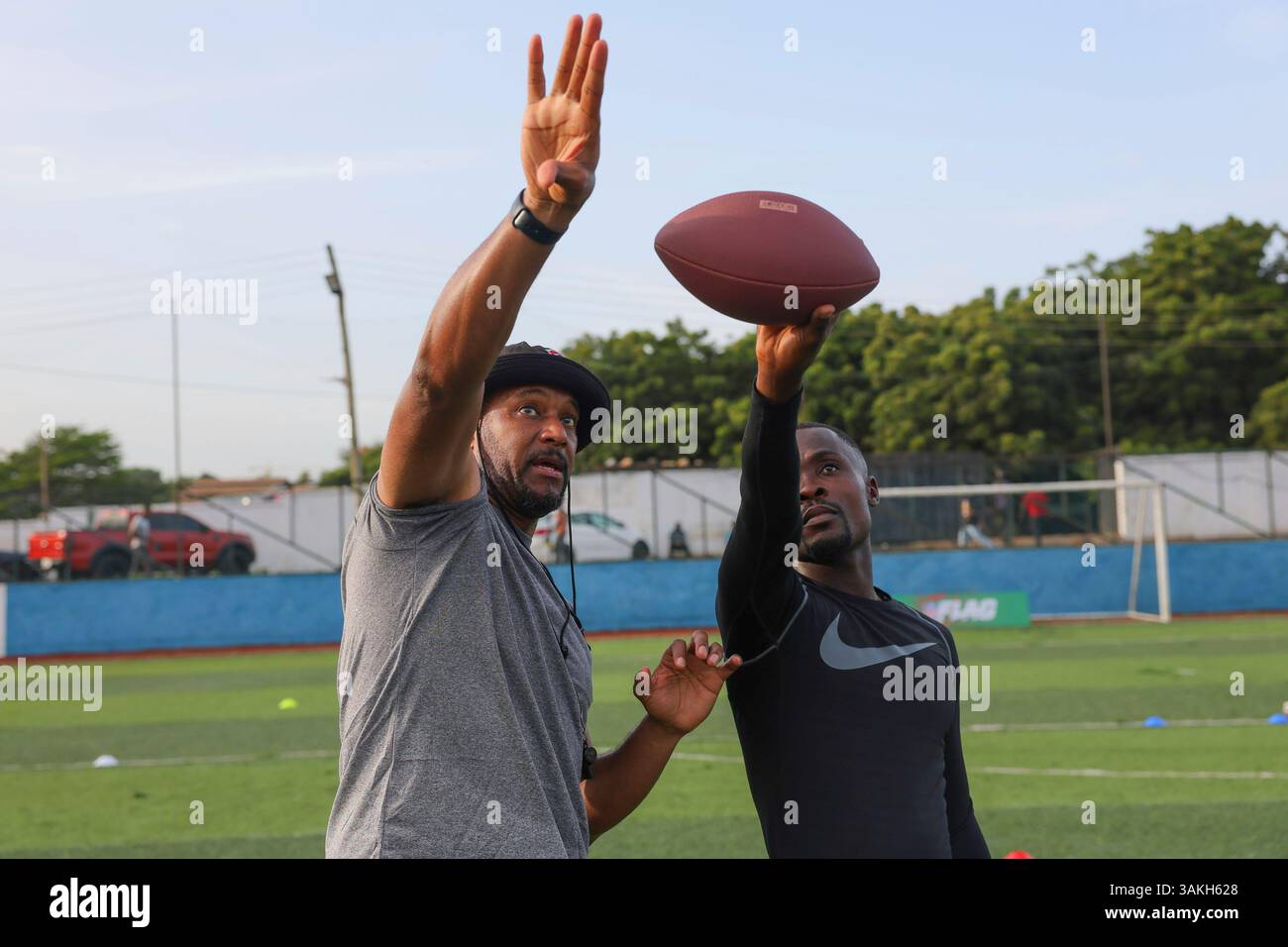 Former NFL player Chris Curd (left) trains a participant during the NFL ...