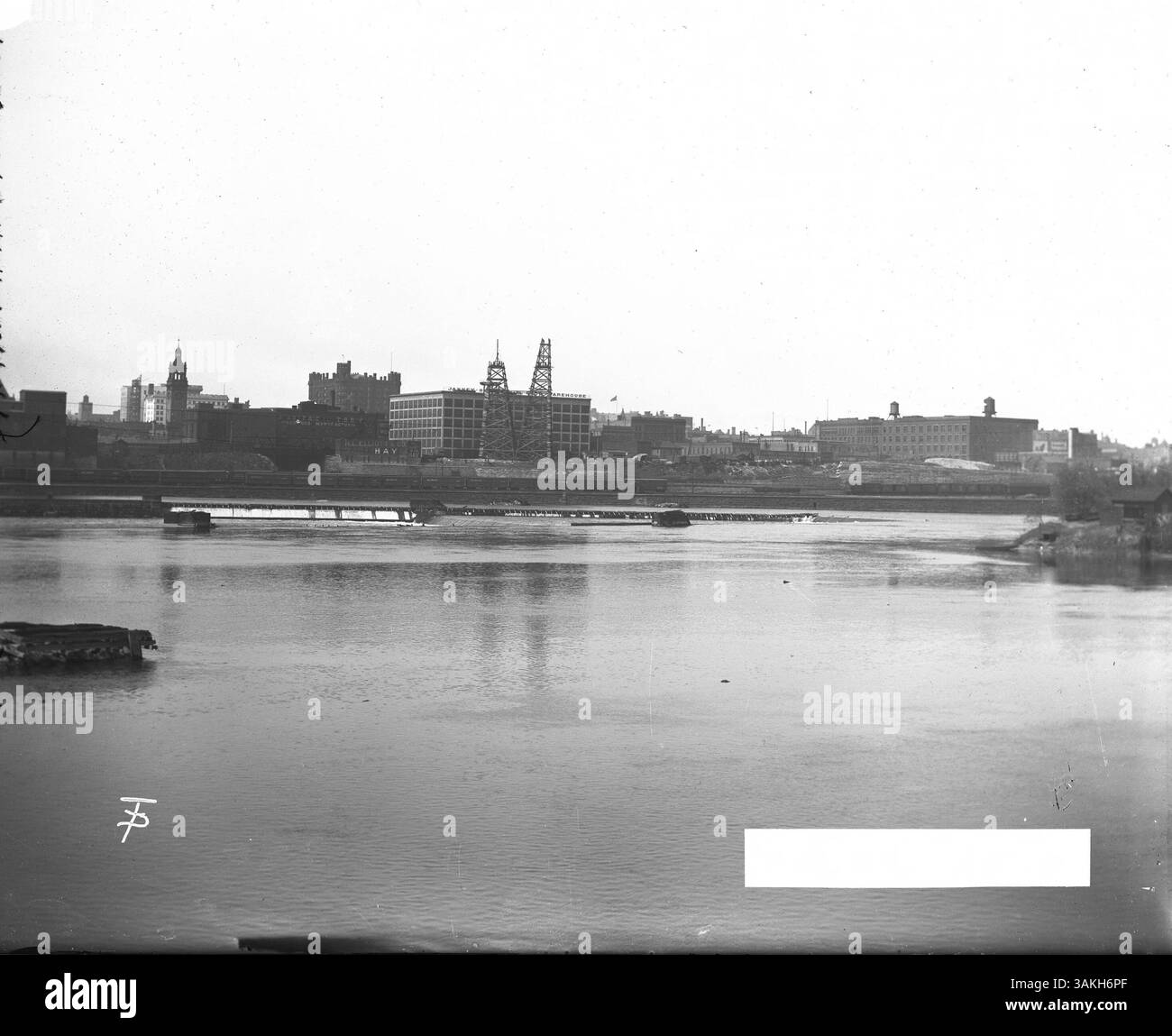This historic image captures the Lower Loop Riverfront, showing key ...