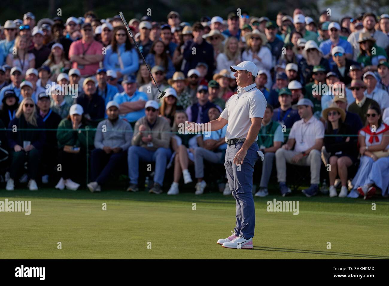 Rory McIlroy, of Northern Ireland, tosses his putter on the 18th hole ...