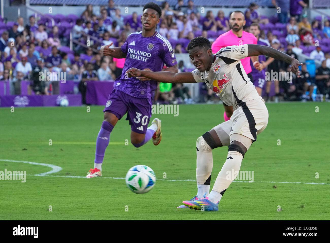 New York Red Bulls defender Omar Valencia, right, takes a shot on goal ...