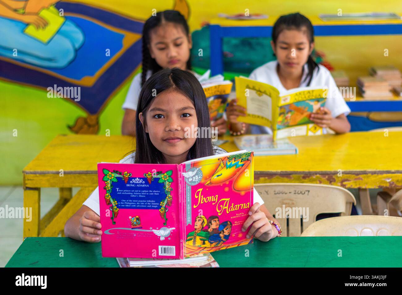 Filipino students enjoy reading time at a public elementary school ...