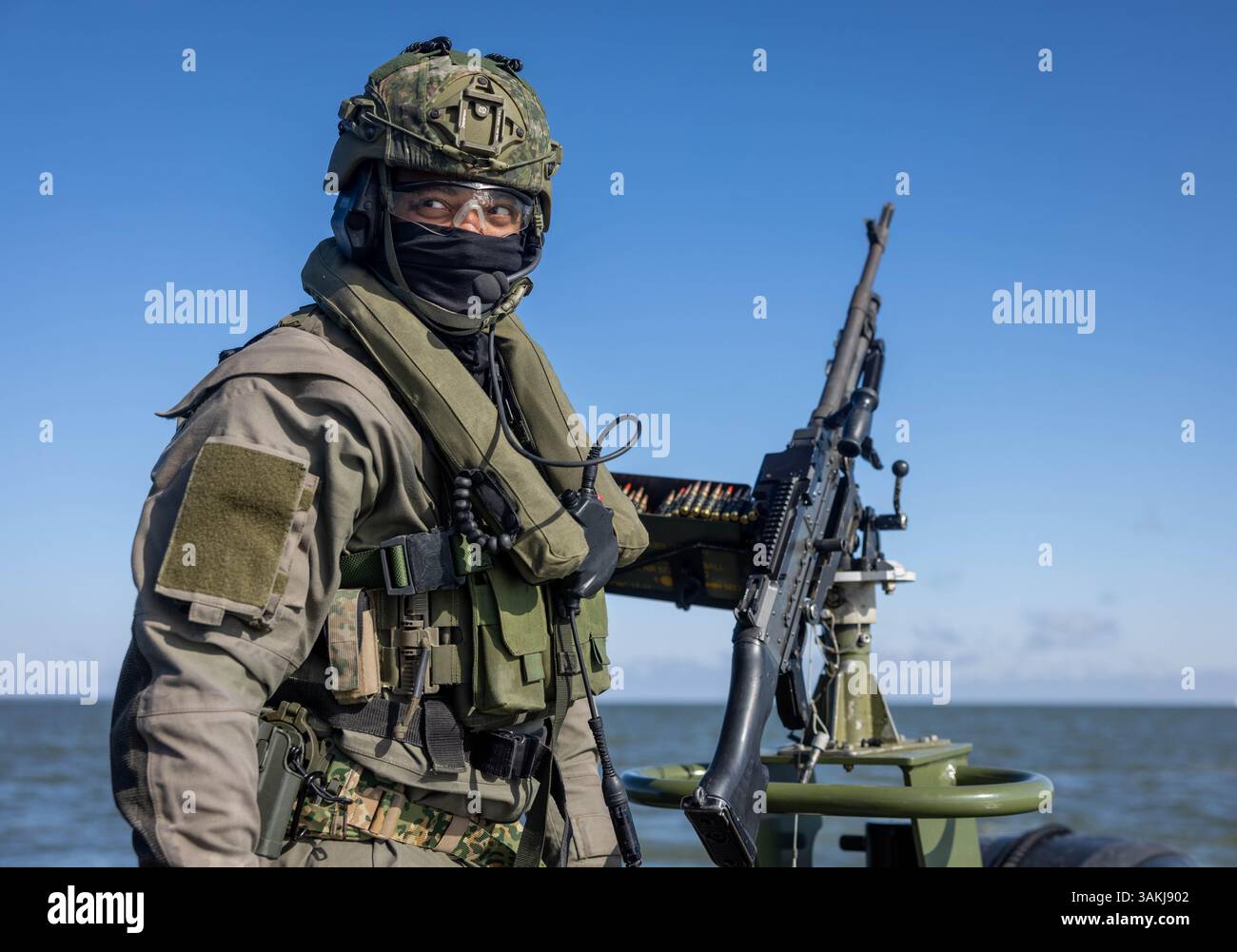 A Korps Marinier with the Royal Netherlands Marine Corps communicates ...