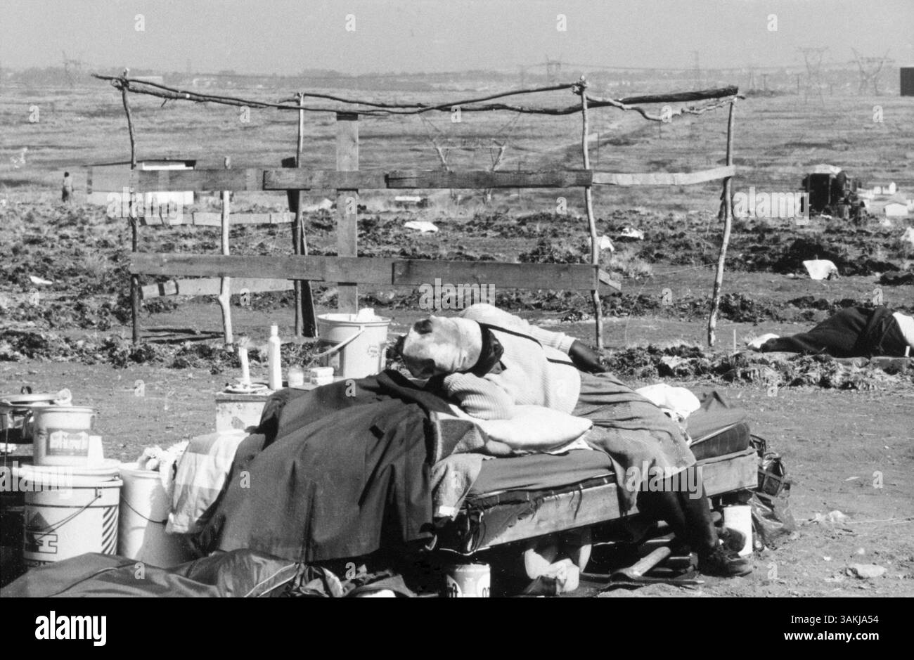 1991 - Johannesburg, Transvaal, South Africa - A woman lays on a bed in ...