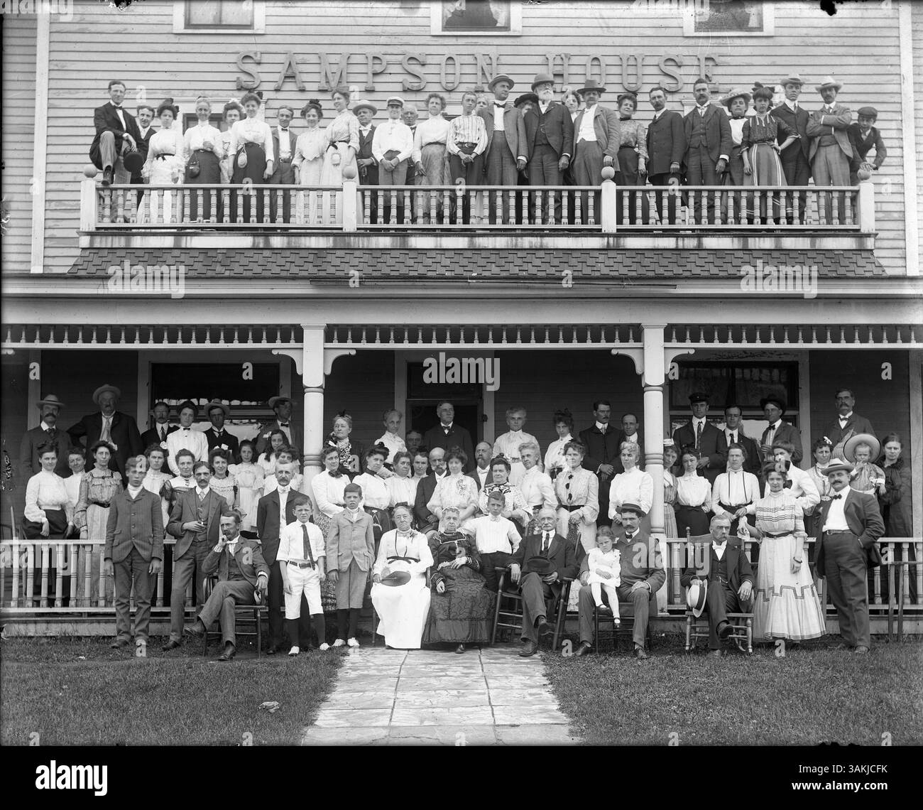 About 100 guests are gathered on the porch and balcony of the Sampson ...