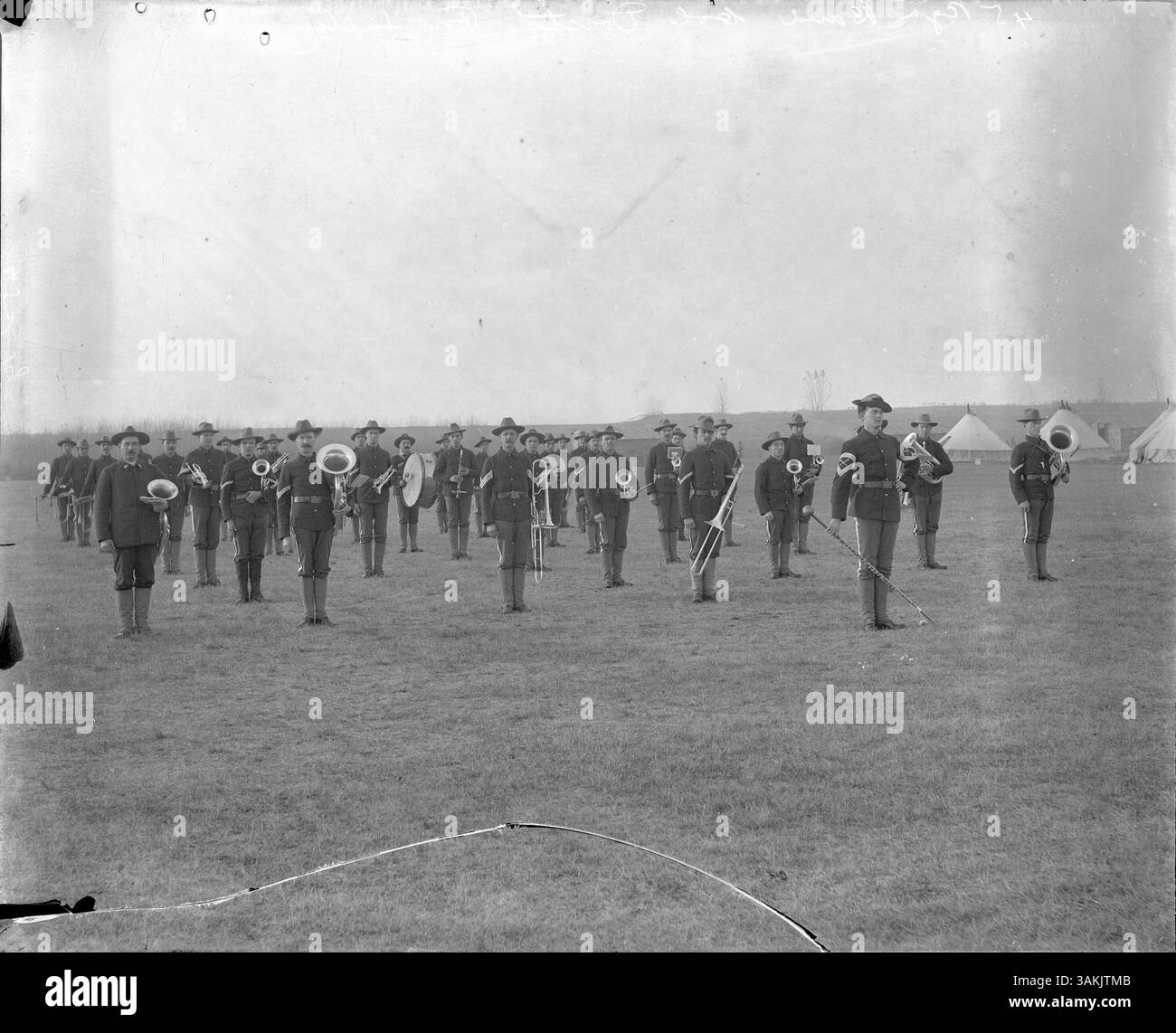 The Band of the 14th Infantry Regiment, led by Colonel Dent, stands at ...