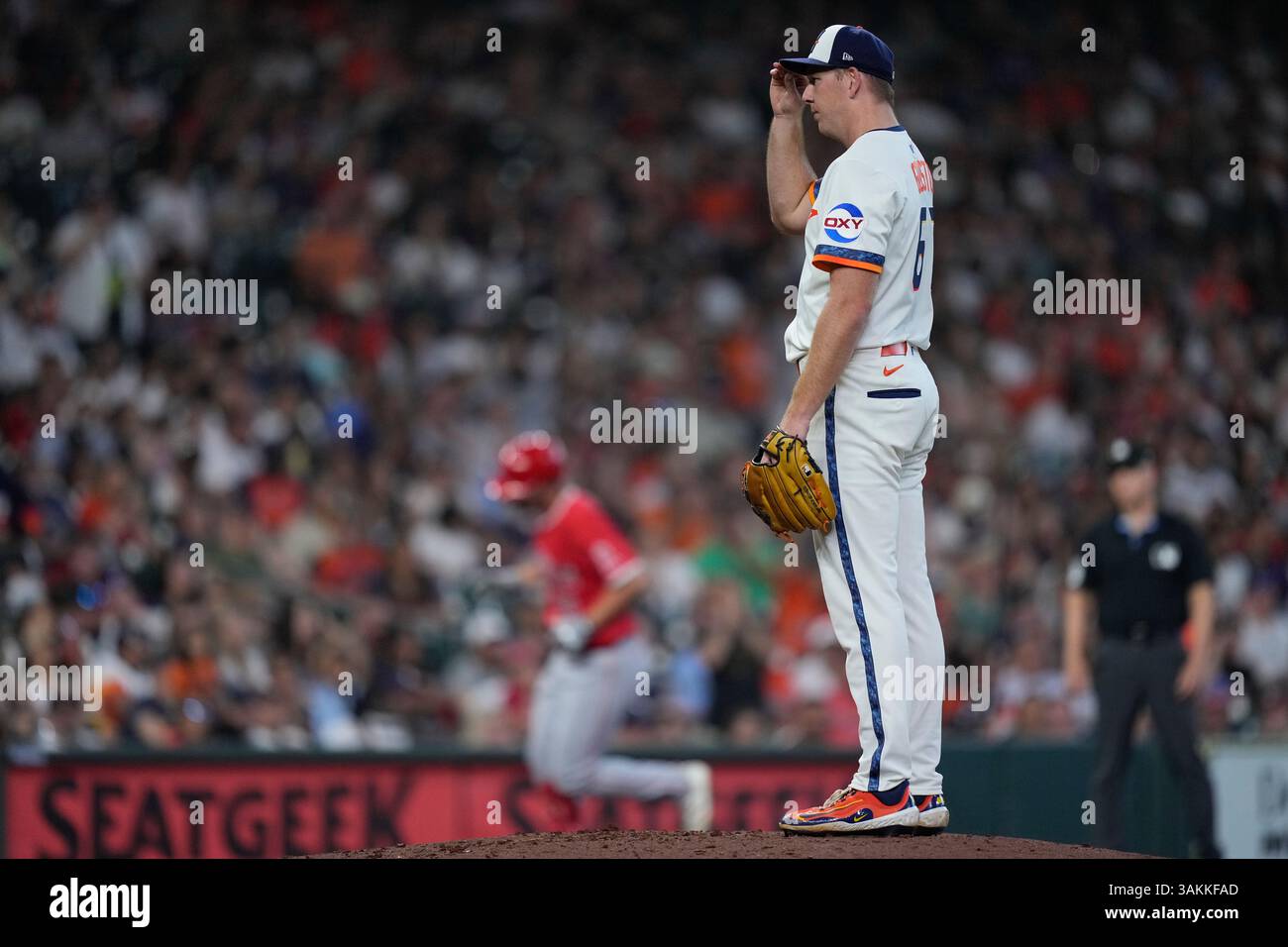 Houston Astros starting pitcher Ryan Gusto, foreground, looks on as Los ...