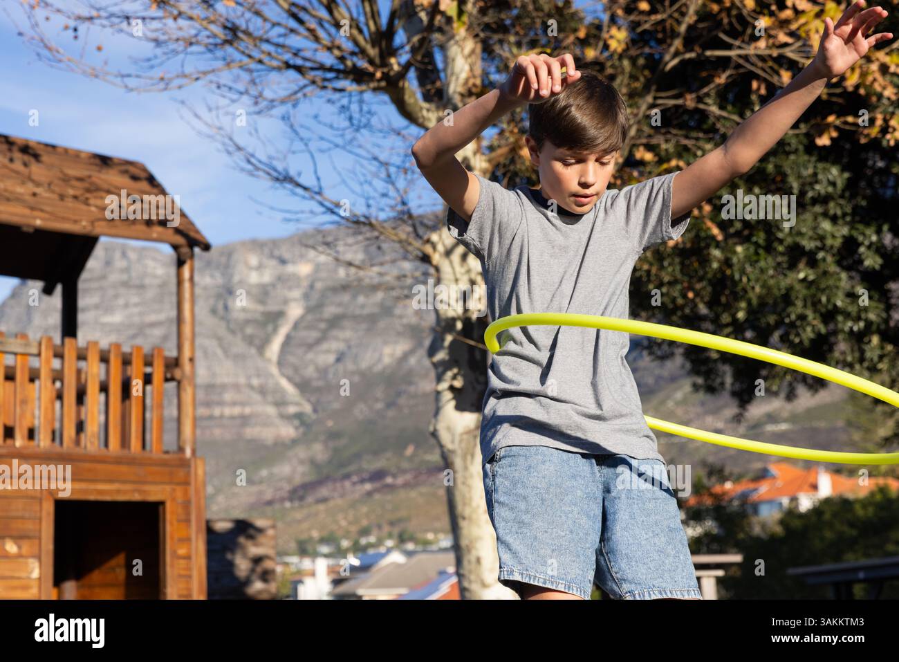 Playing with hula hoop, boy enjoying outdoor activity at school ...