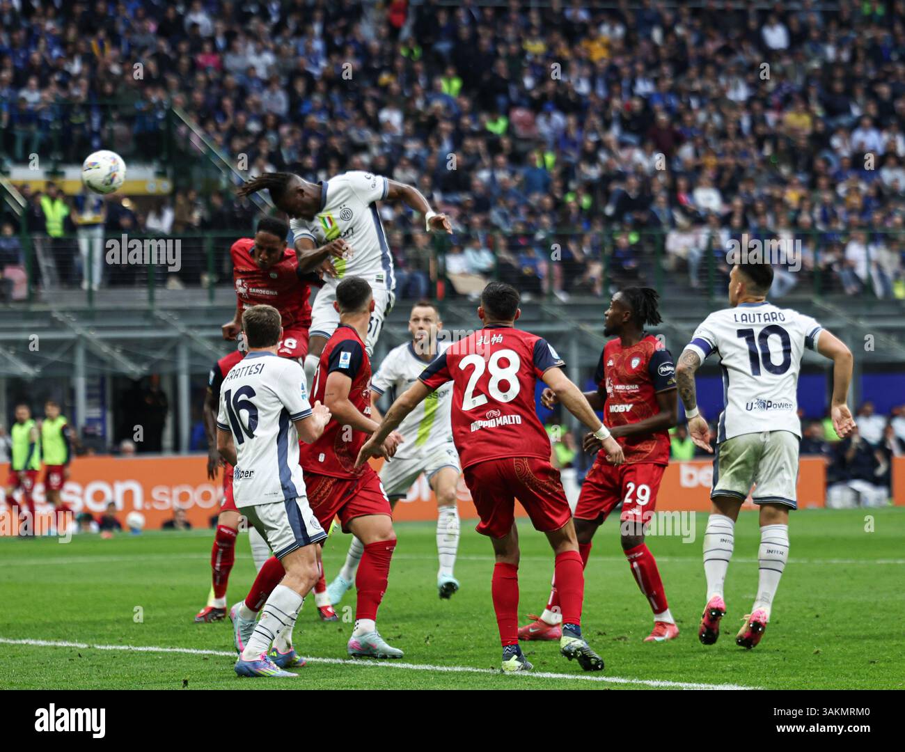 Milan, Italy. 12th Apr, 2025. Inter Milan's Yann Bisseck (top R) heads ...