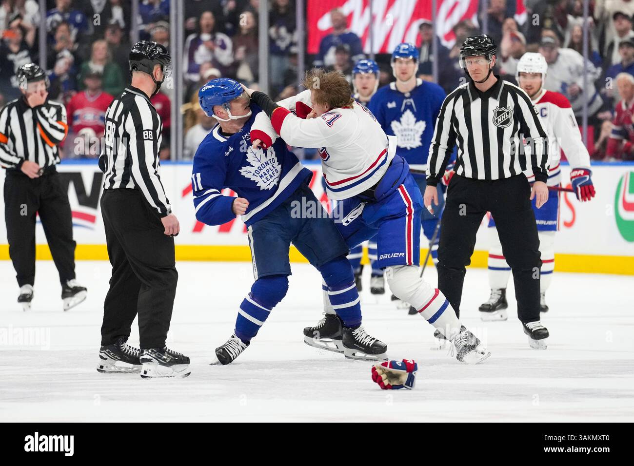 Montreal Canadiens' Kaiden Guhle (21) and Toronto Maple Leafs' Max Domi ...