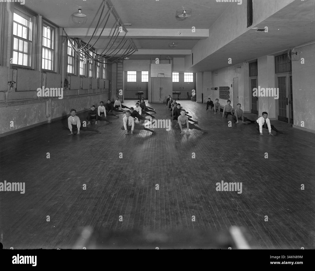 Boys participate in a physical education class inside the Grant School ...