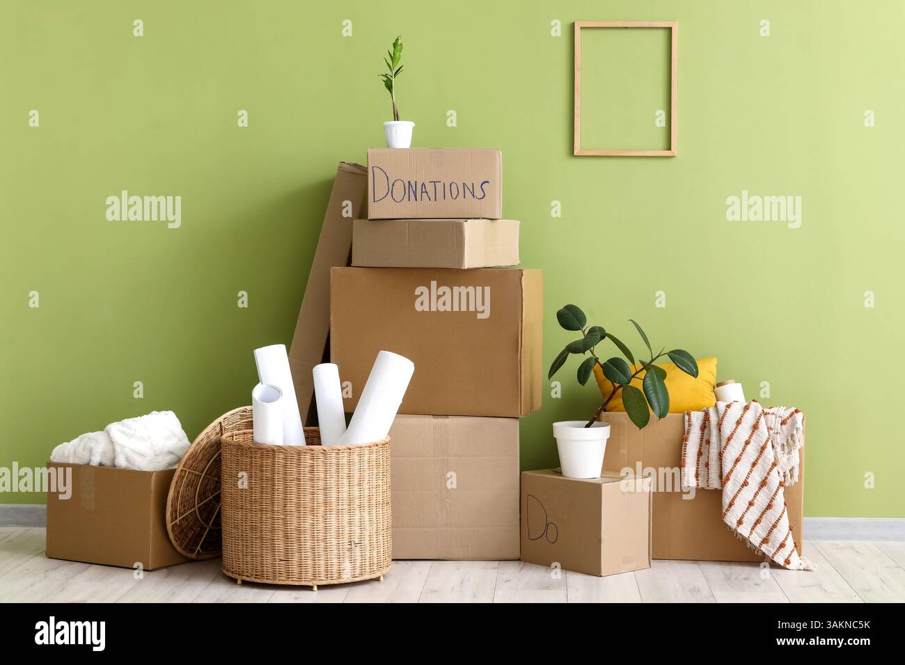 Cardboard boxes for donations near green wall in room Stock Photo - Alamy