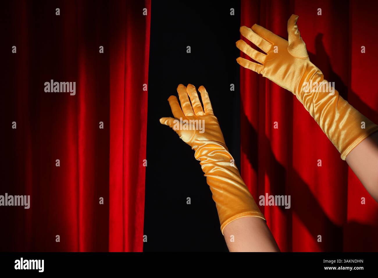 Female hands in gloves and open red curtains on black background Stock ...