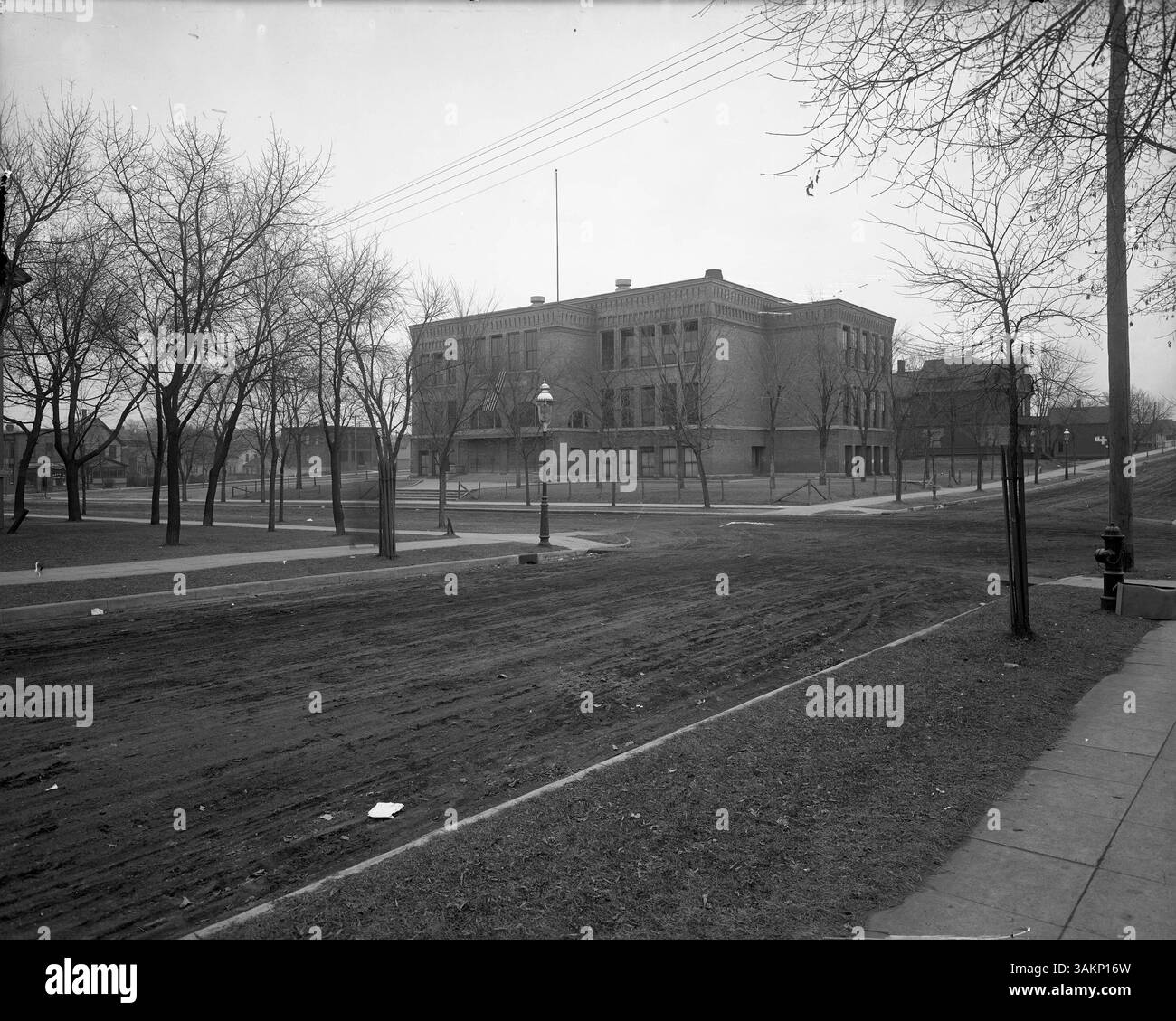 The Clinton School, with its adjacent boarded-up house, showcases a ...