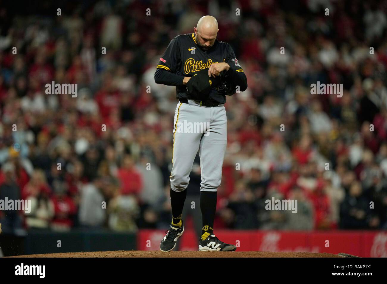 Pittsburgh Pirates pitcher Tim Mayza adjusts his hat in the seventh ...