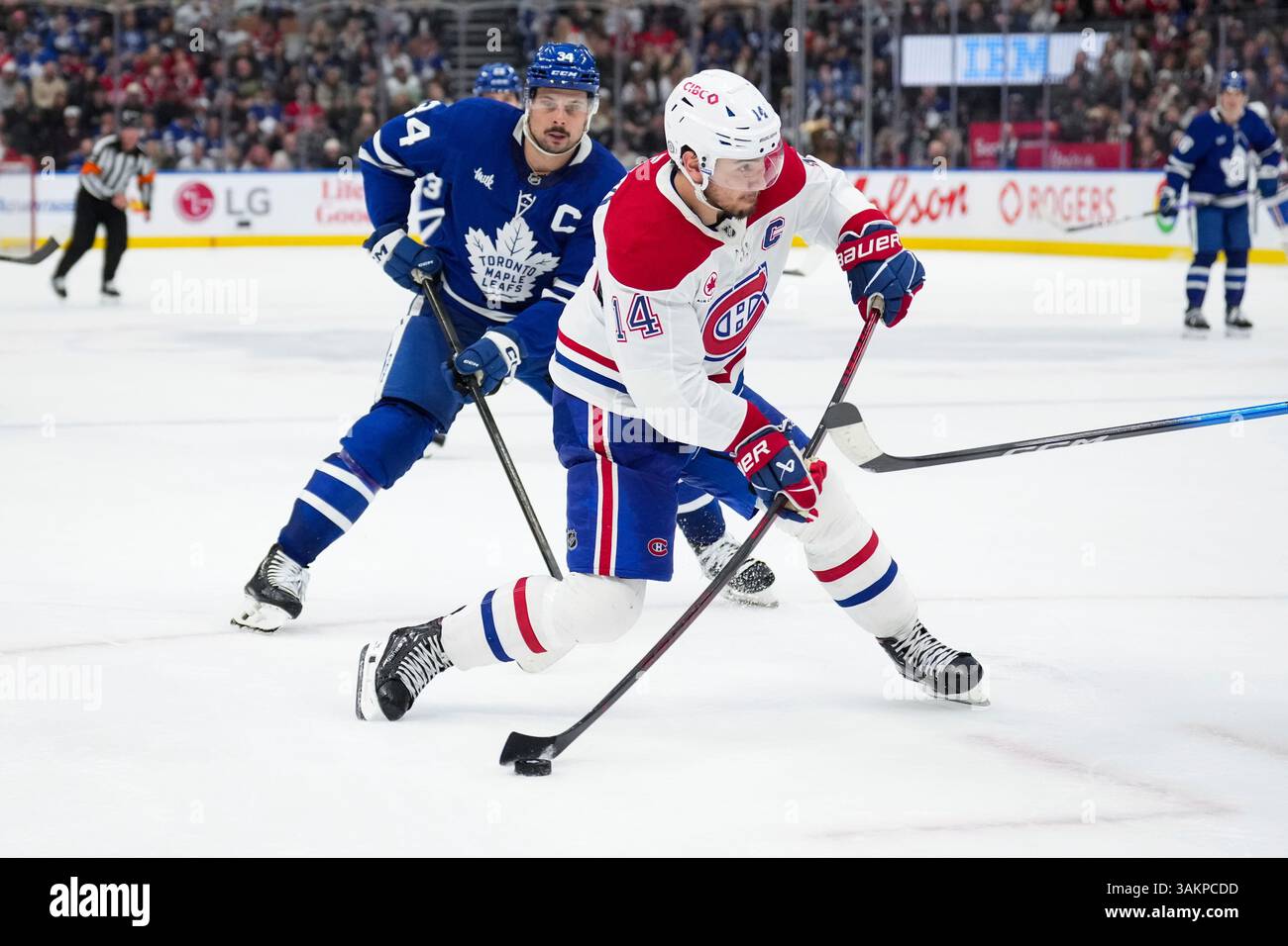 Montreal Canadiens' Nick Suzuki (14) shoots the puck as Toronto Maple ...
