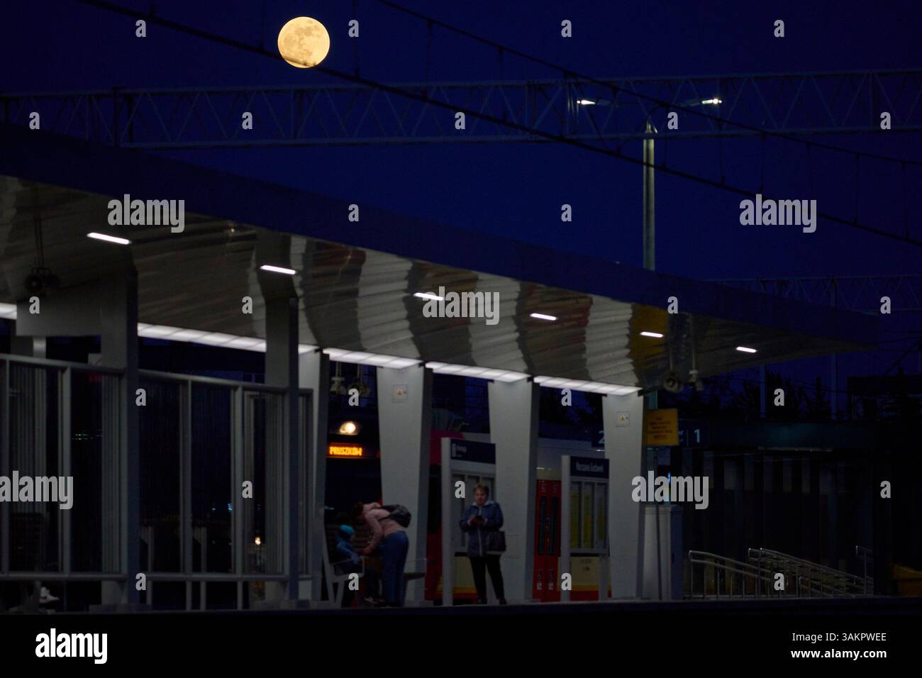 Warsaw, Poland. 12th Apr, 2025. A full moon is seen in the sky over ...
